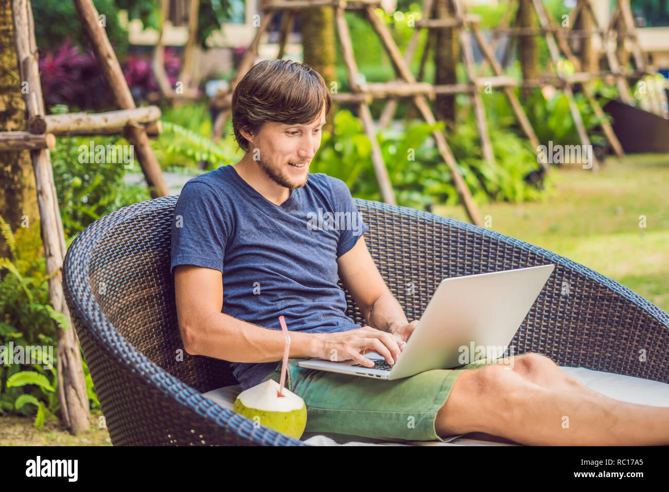 Young freelancer working on vacation next to the swimming pool Stock ...