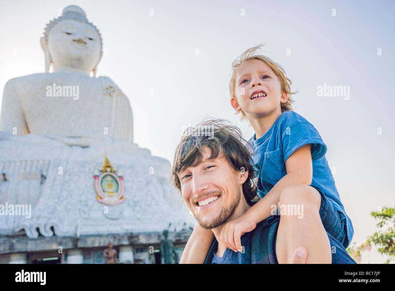 Father and son tourists on the Big Buddha statue. Was built on a high ...