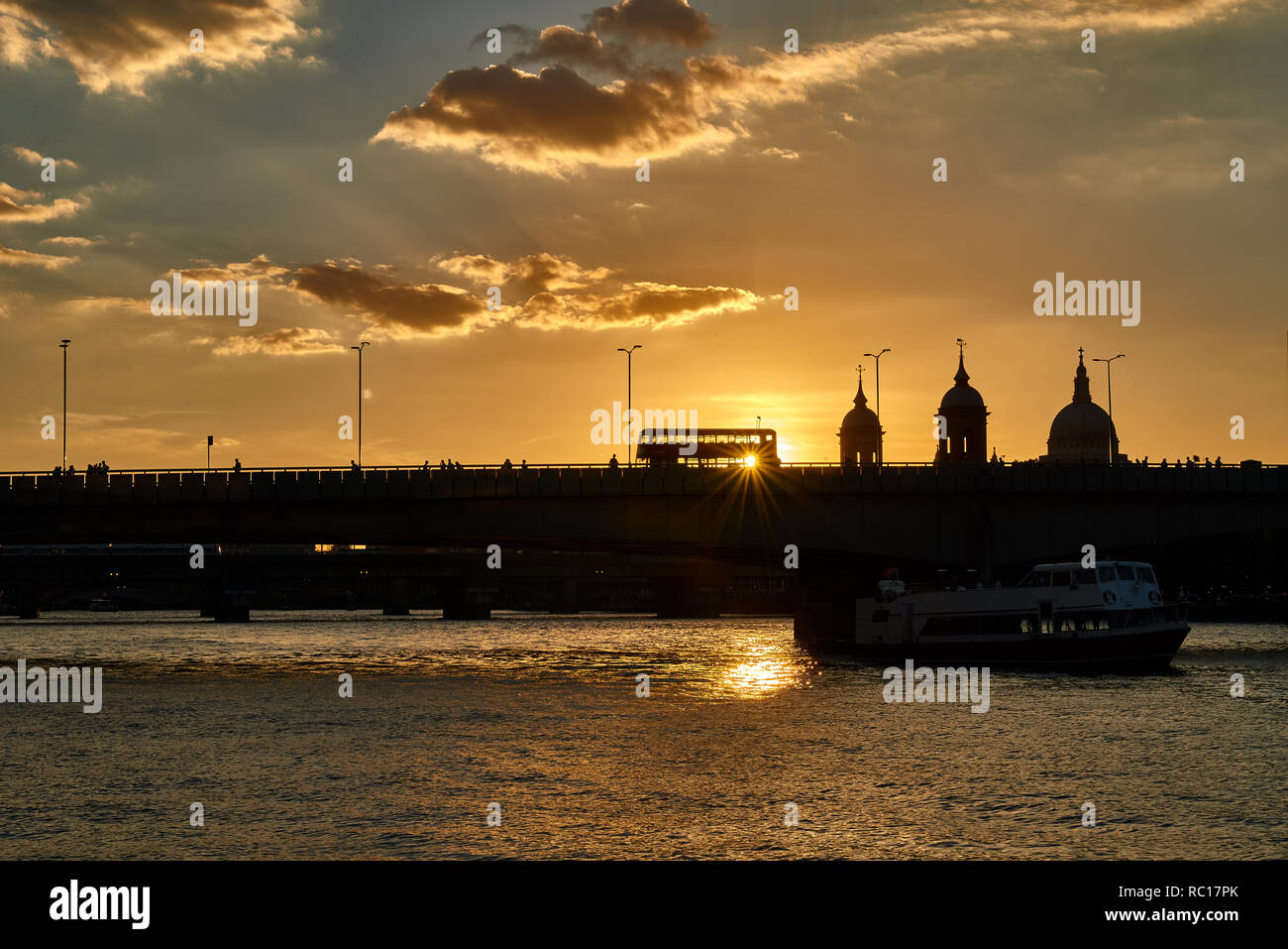 London sunset cityscape view with silhouette of double decker bus and ...