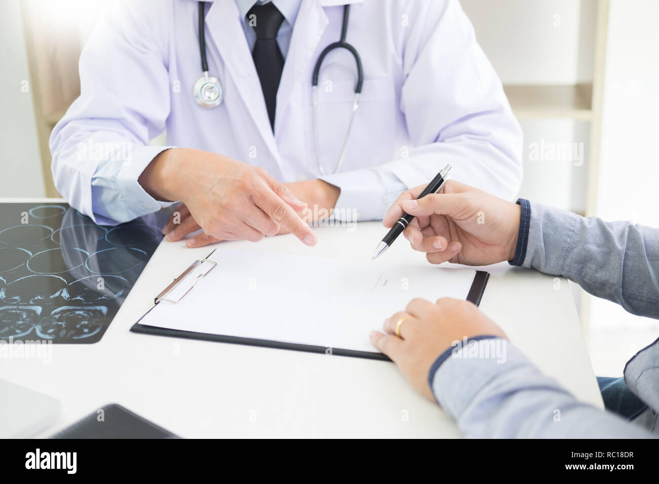 doctor giving a consultation discussing to patient and explaining ...