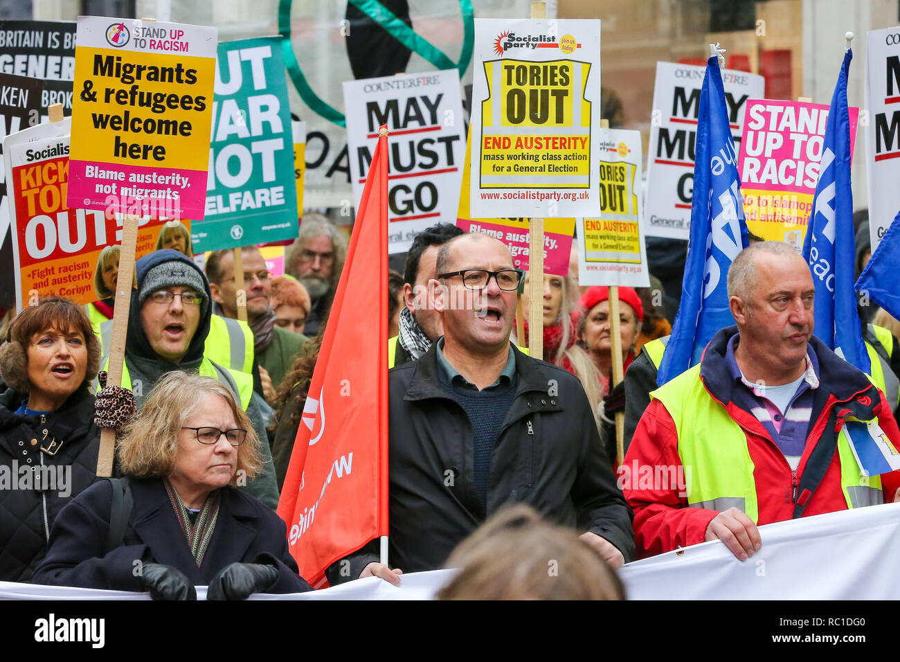 London, UK. 12th Jan, 2019. Protesters are seen holding placards while ...