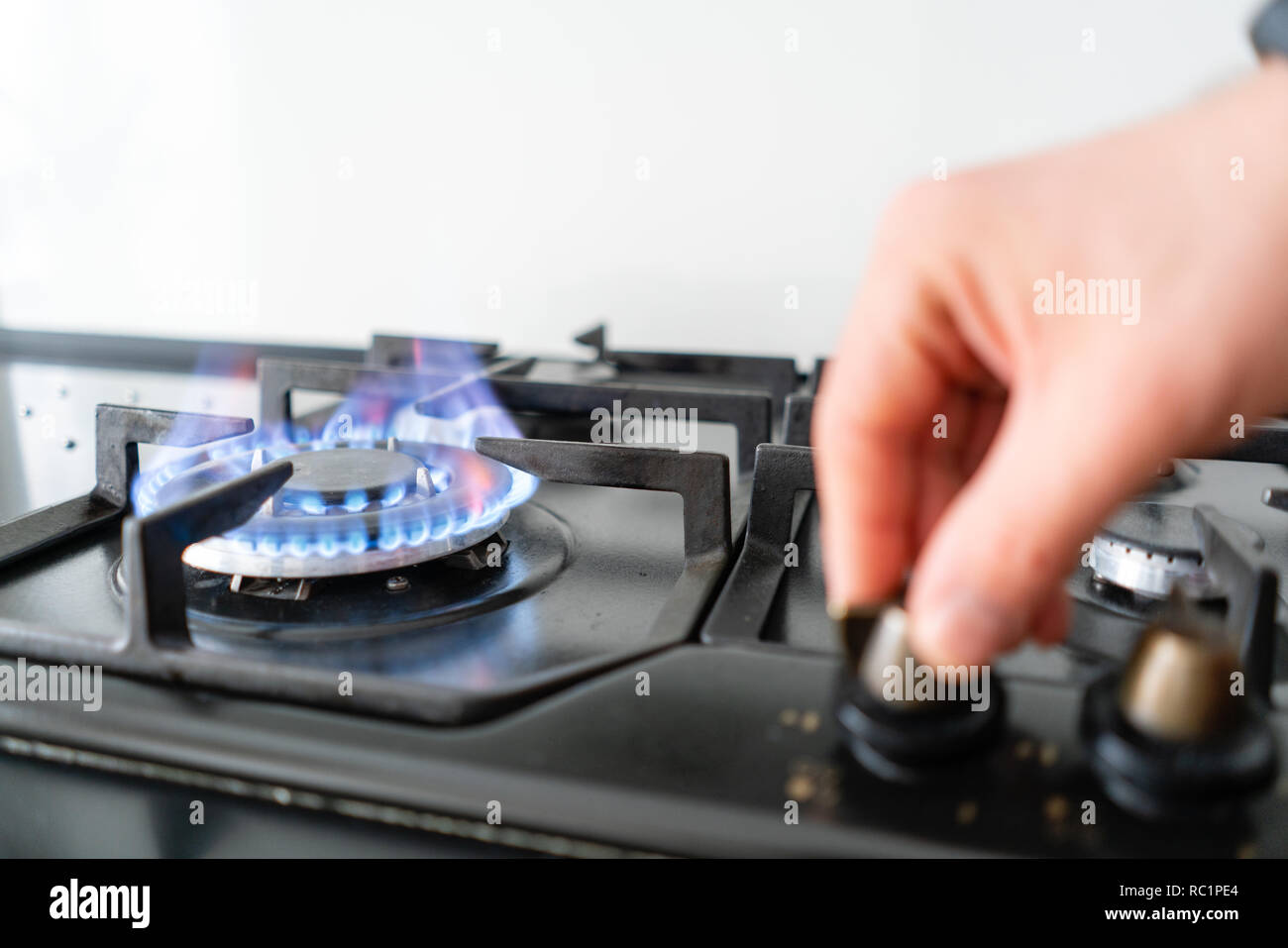 Closeup shot of blue fire from domestic kitchen hob. Gas cooker with ...
