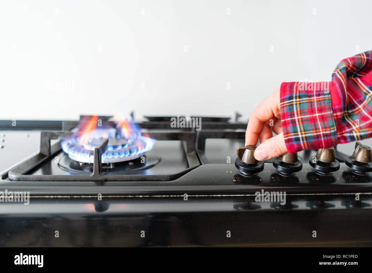 Closeup shot of blue fire from domestic kitchen hob. Gas cooker with ...