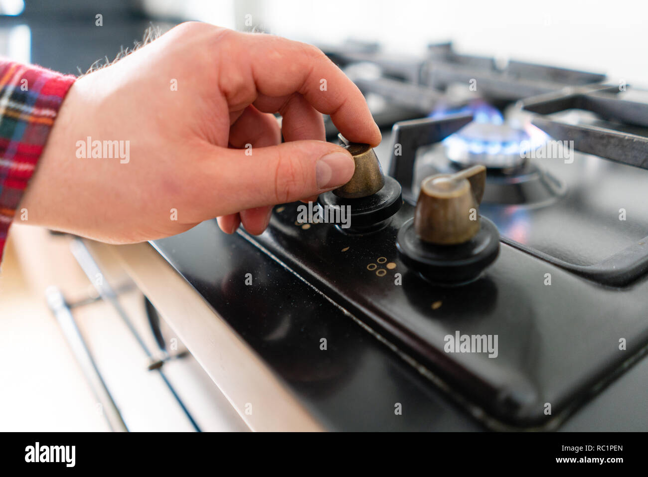 Closeup shot of blue fire from domestic kitchen hob. Gas cooker with ...