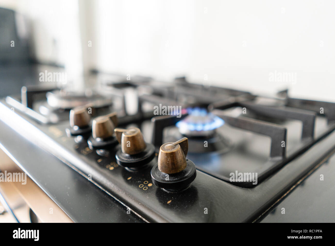 Closeup shot of blue fire from domestic kitchen hob. Gas cooker with ...