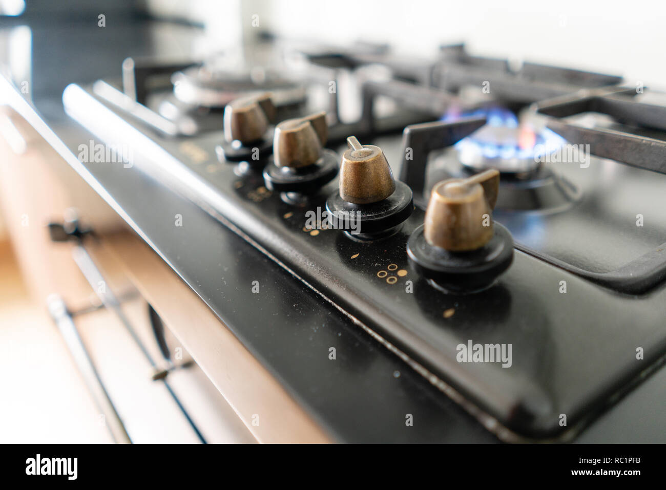 Closeup shot of blue fire from domestic kitchen hob. Gas cooker with ...