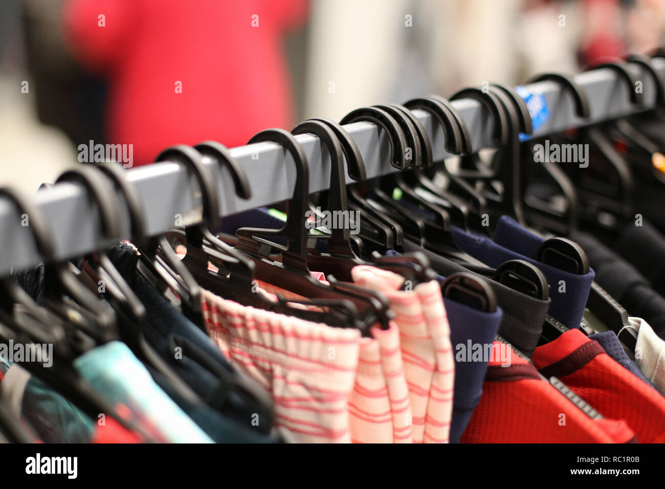 Details with clothes on hangers in a clothing store inside a shopping ...