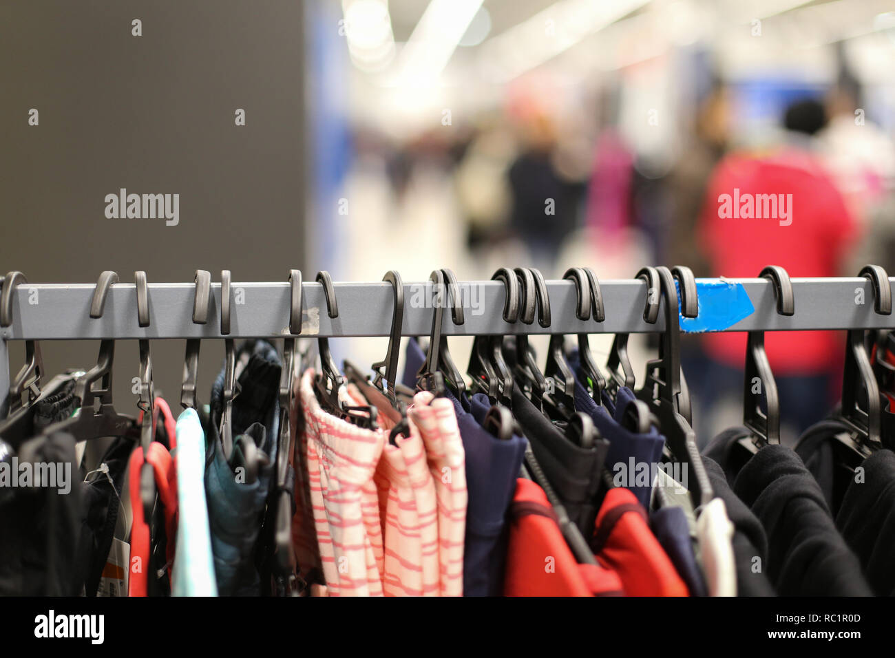 Details with clothes on hangers in a clothing store inside a shopping ...