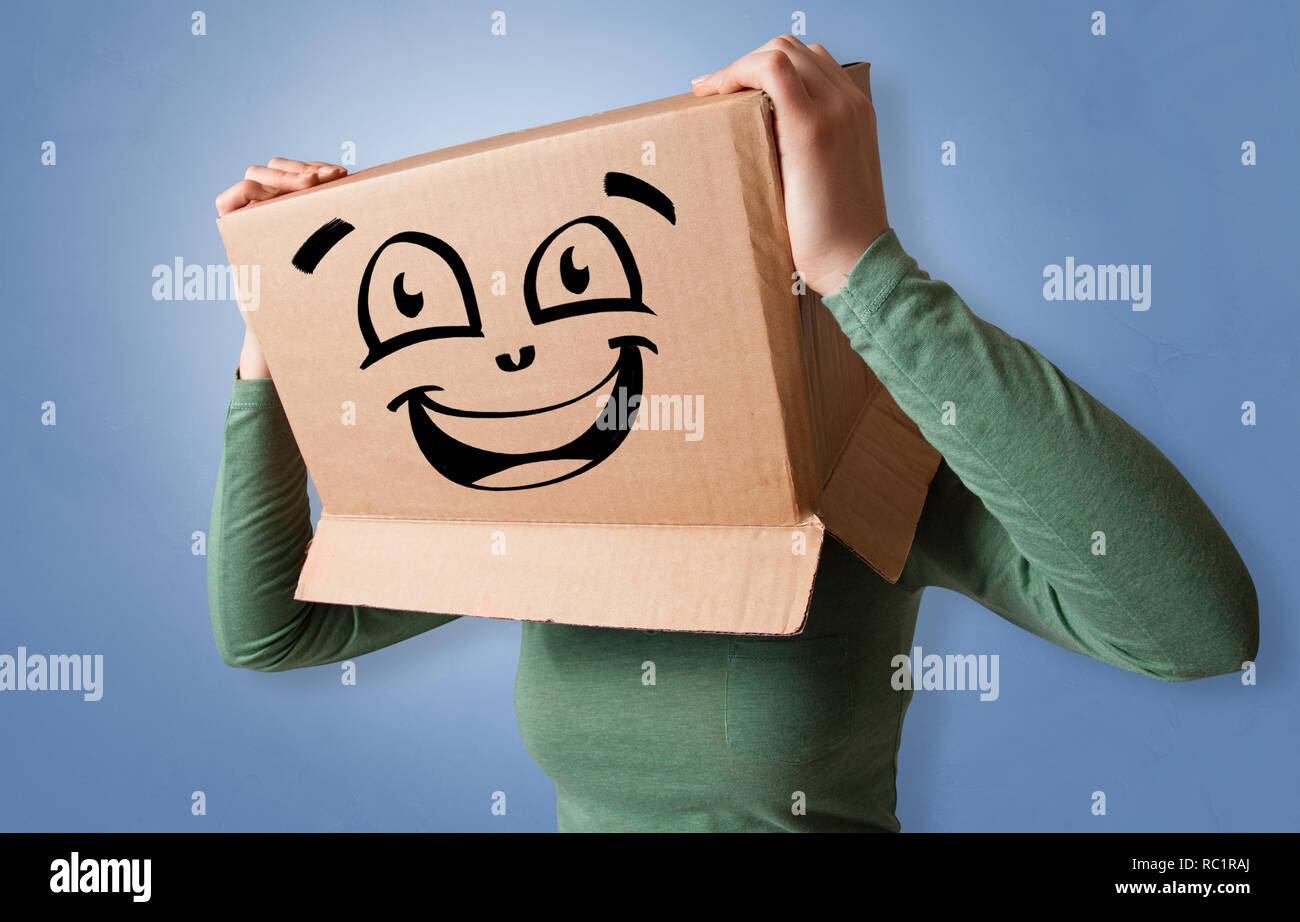 Young woman with happy face illustrated cardboard box on her head Stock ...