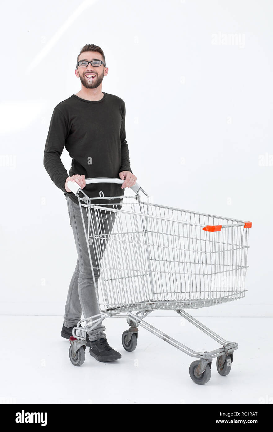young man with a shopping cart steps forward Stock Photo - Alamy