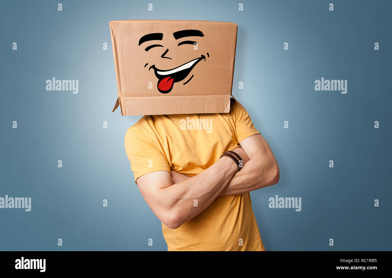 Young boy standing and gesturing with a cardboard box on his head Stock ...