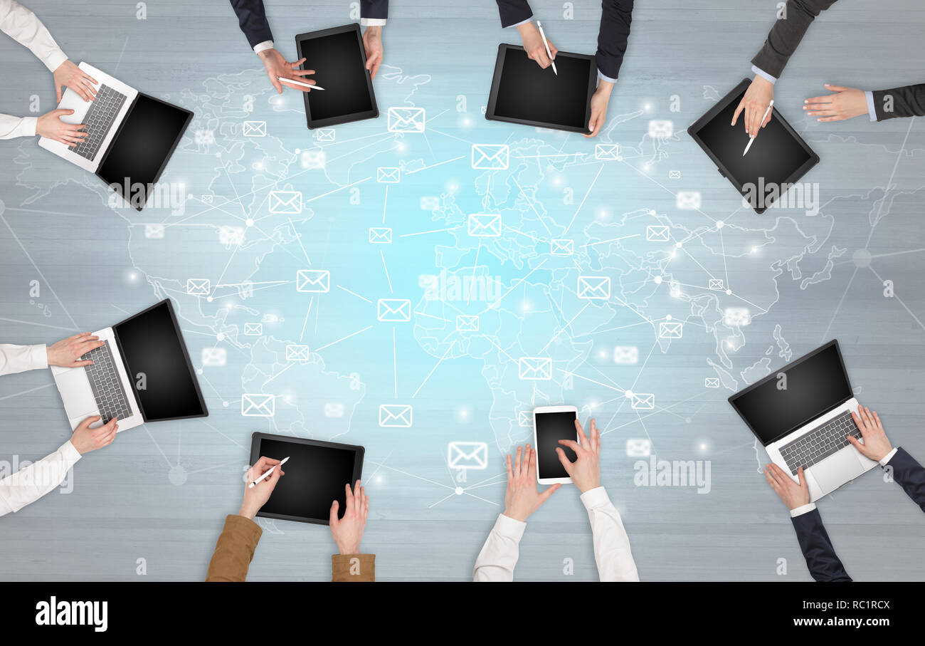 Group of people with devices in hands working in team on tablets ...