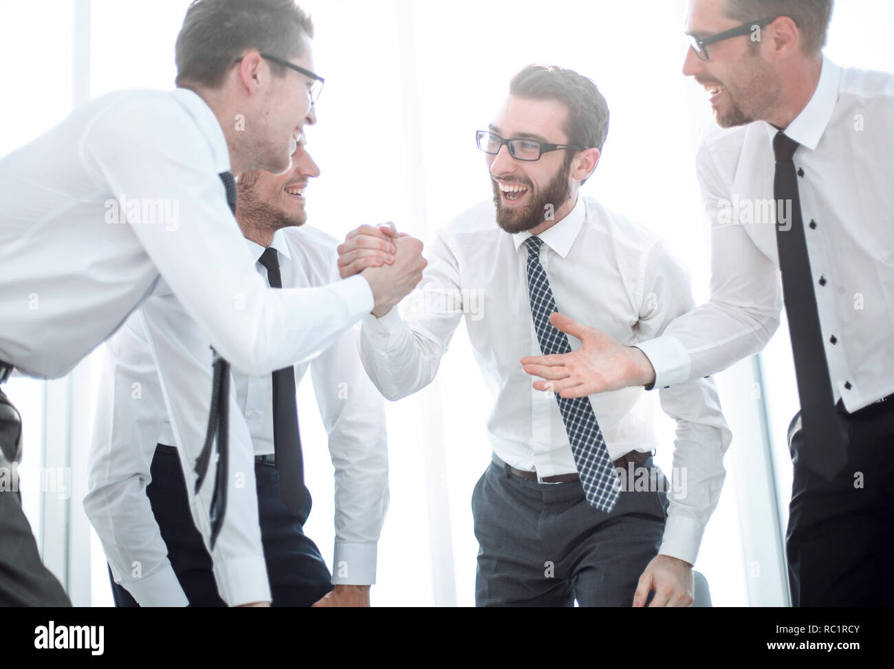 close up.happy employees shaking hands Stock Photo - Alamy