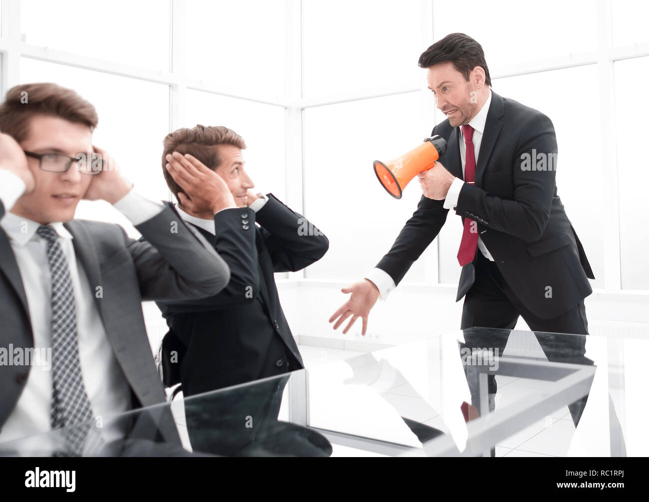 strict businessman yelling at colleagues during a business meeting ...