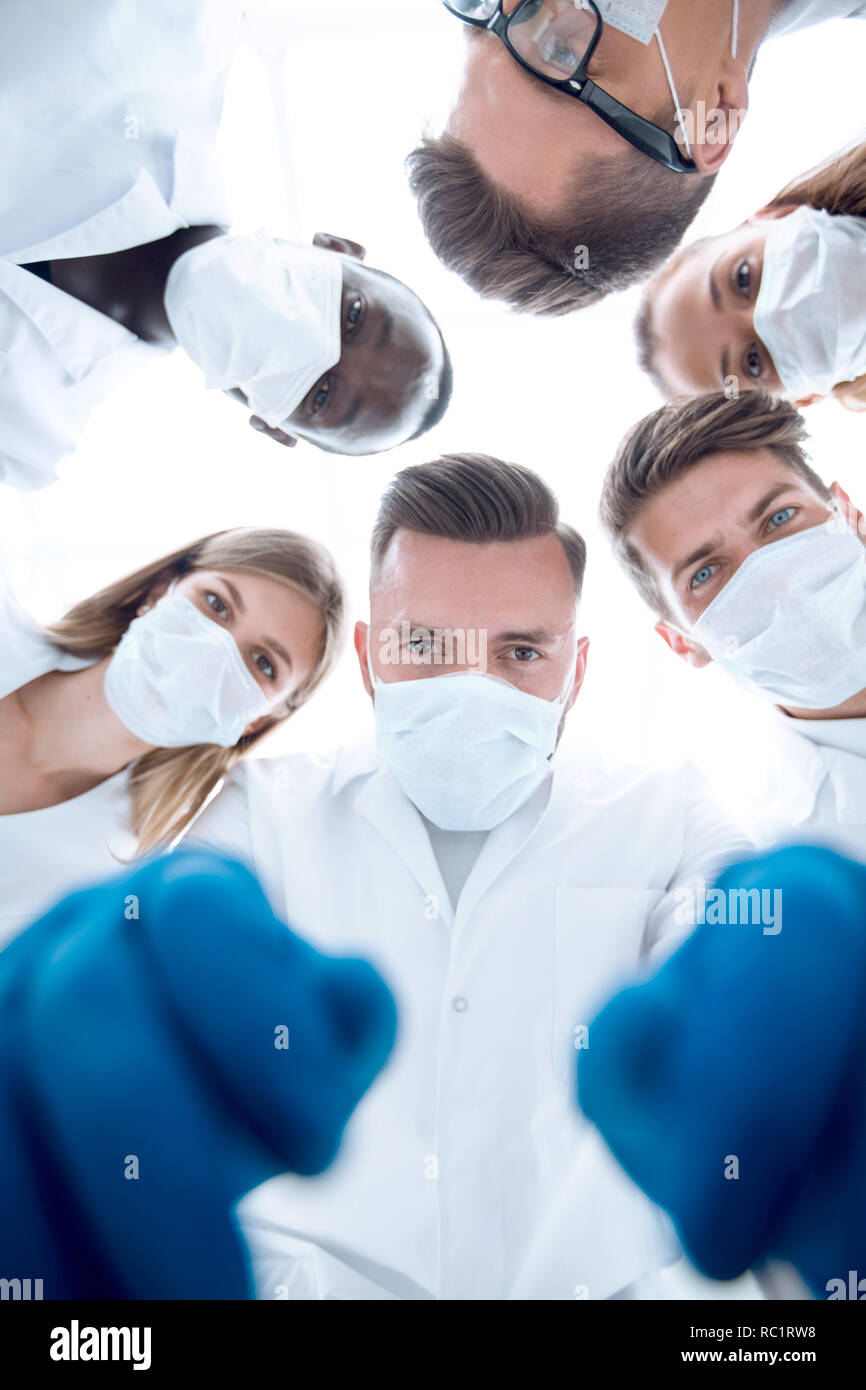 Team of medical doctors looking down at patient Stock Photo - Alamy