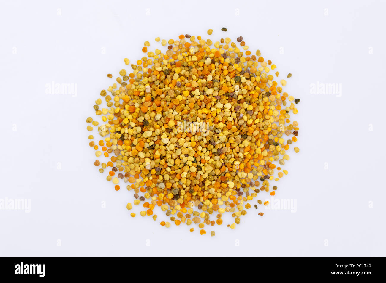 A scattering of bee pollen on a white background. Bright pollen. Bee ...