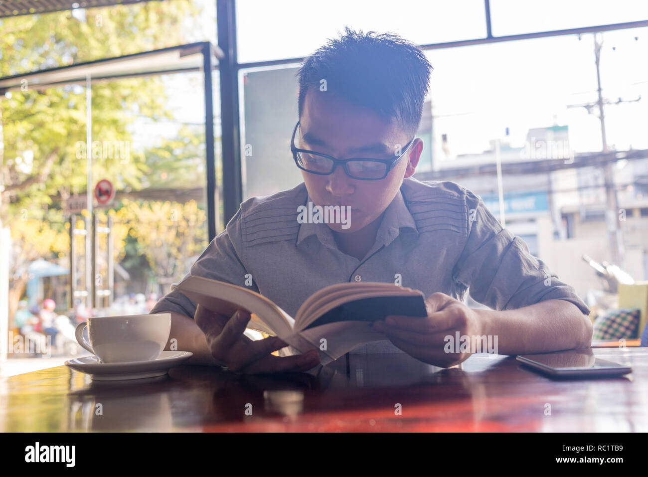 Reading favourite book at cafe in the summer day Stock Photo - Alamy