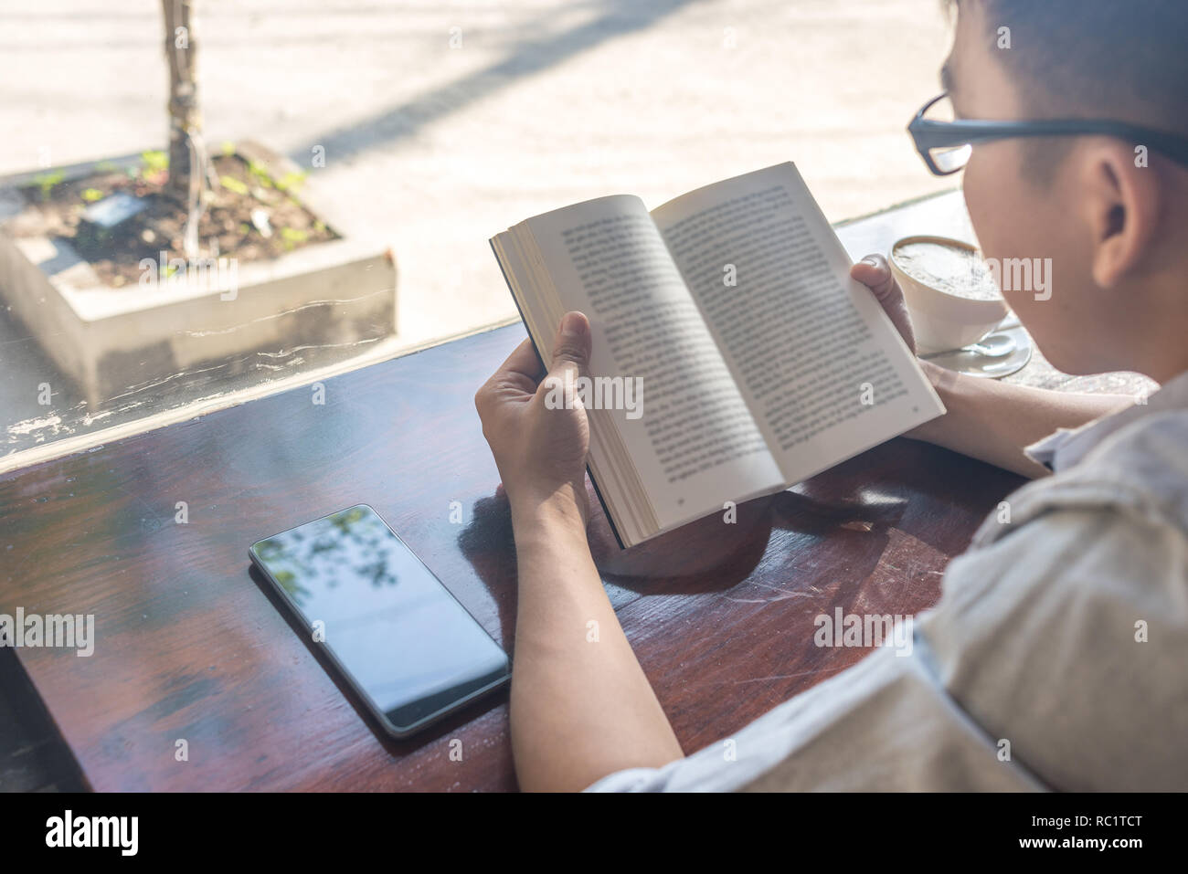 Reading book is good way to improve useful knowledge Stock Photo - Alamy