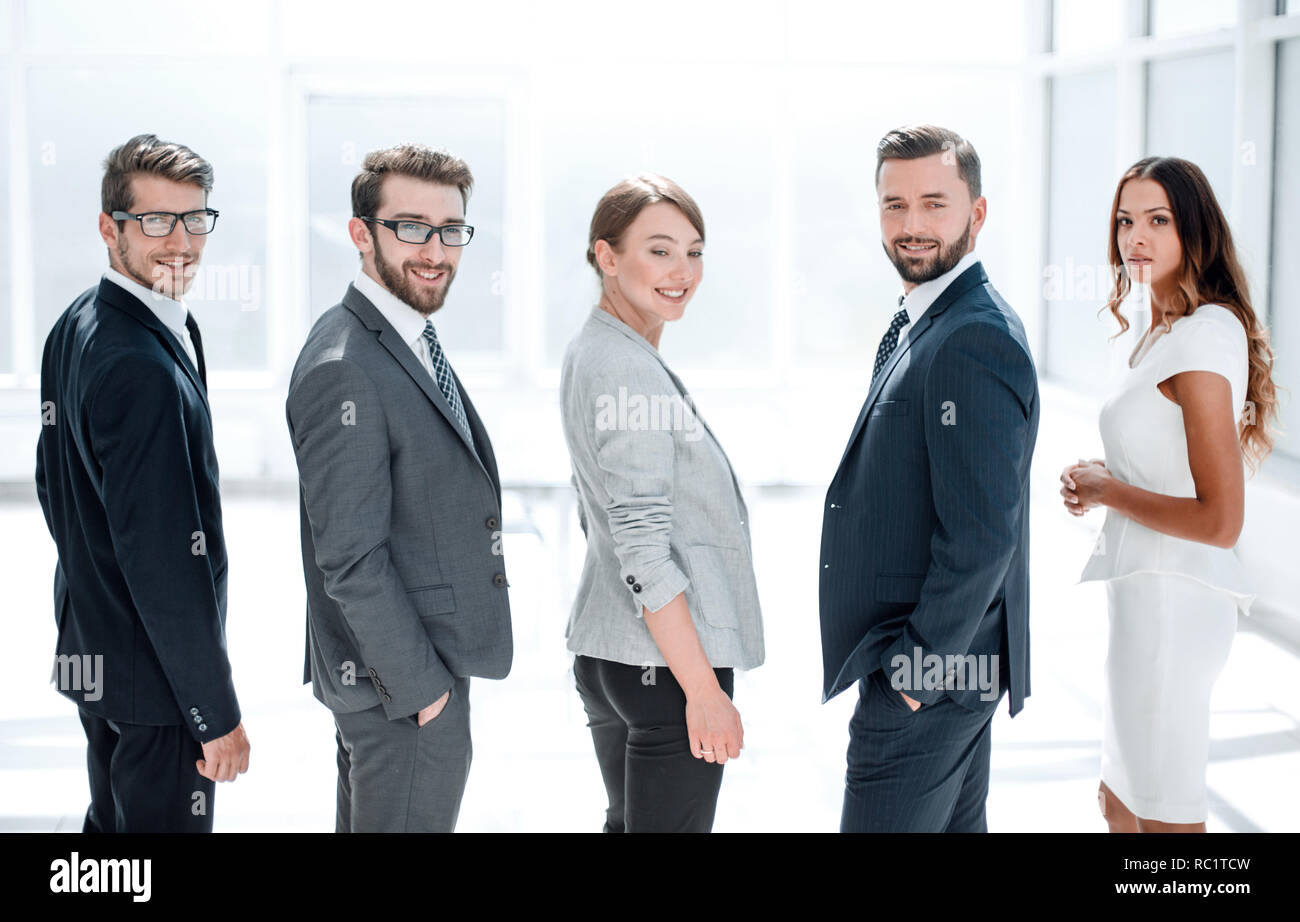 rear view.business team smiling and looking at the camera Stock Photo ...