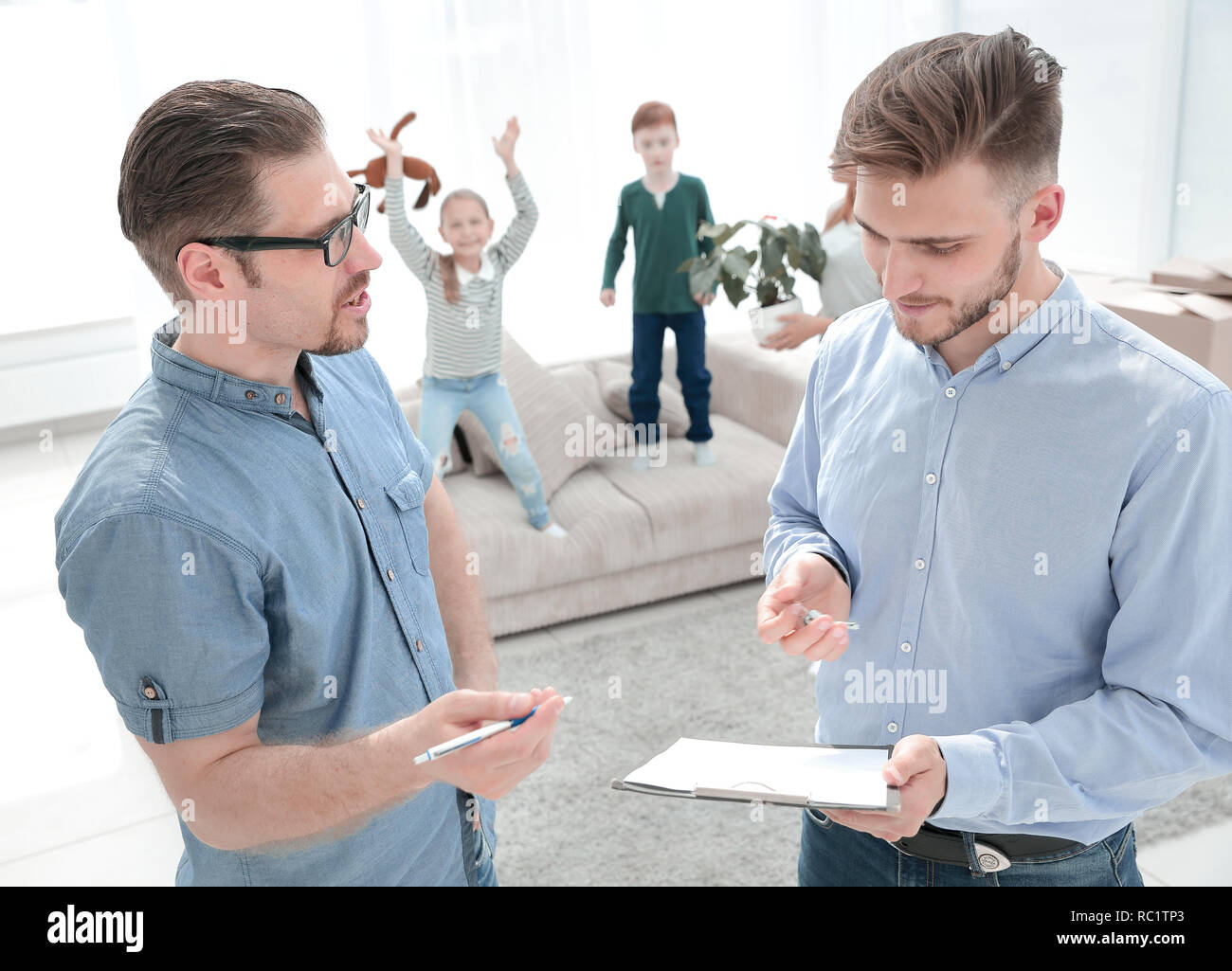 real estate agent and client standing in new apartment Stock Photo - Alamy