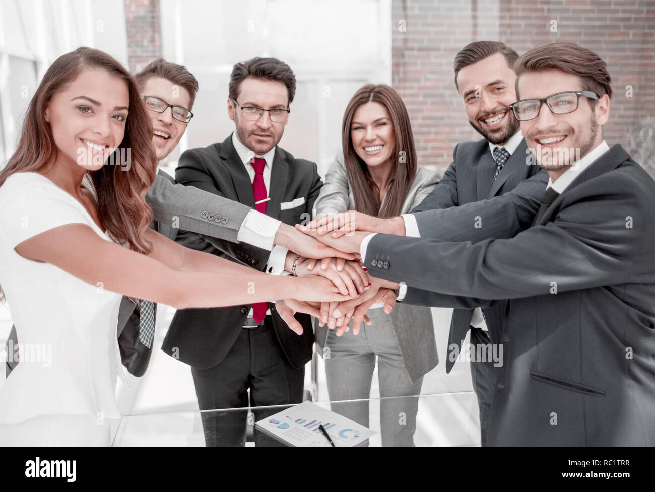 happy business team joining hands together Stock Photo - Alamy