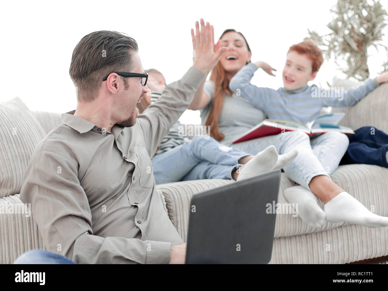 happy family giving high five in their living room Stock Photo - Alamy