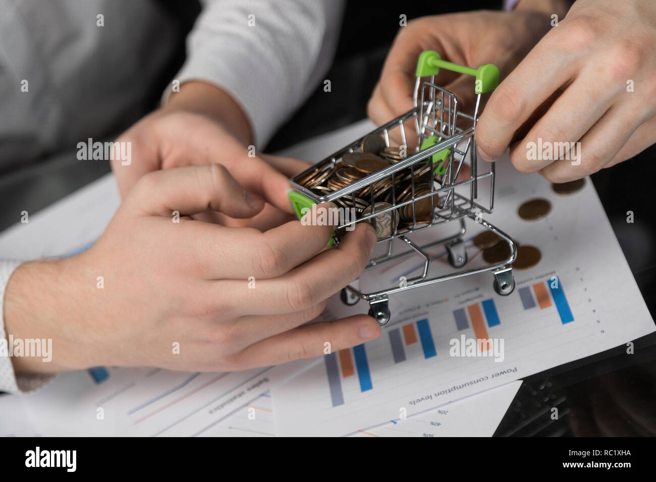 Men's hands pulled in different directions Dummy shopping cart filled ...