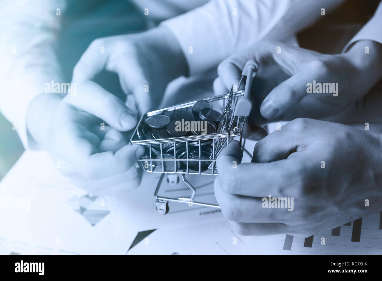 Men's hands pulled in different directions Dummy shopping cart filled ...