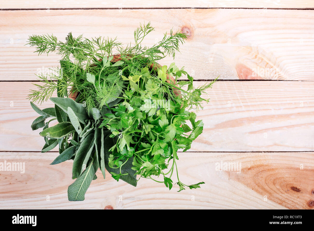 Fresh herb leaves variety in wood bowl on table Stock Photo - Alamy