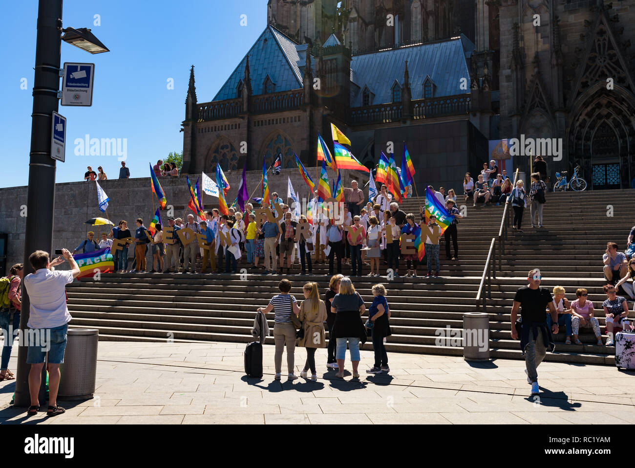 Cologne, Germany. People sitting on the stairs next to Cologne central ...