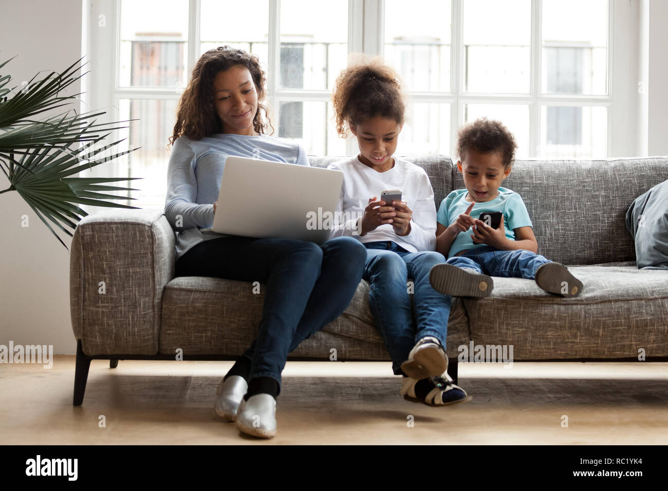 Mom using phone with kids hi-res stock photography and images - Alamy