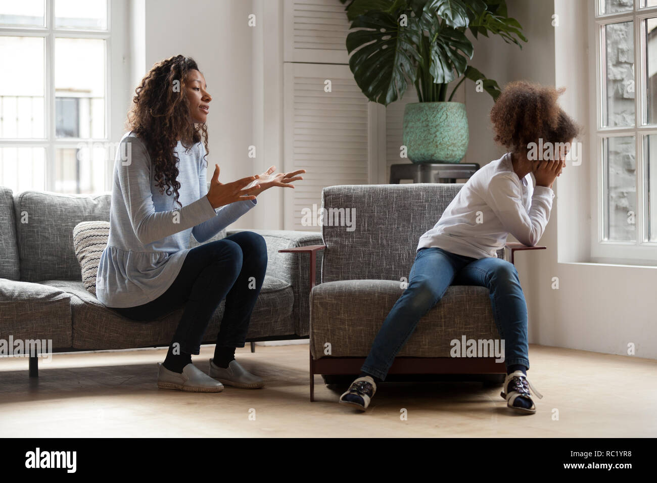 Stubborn african kid ignoring mom scolding, parent and child con Stock ...