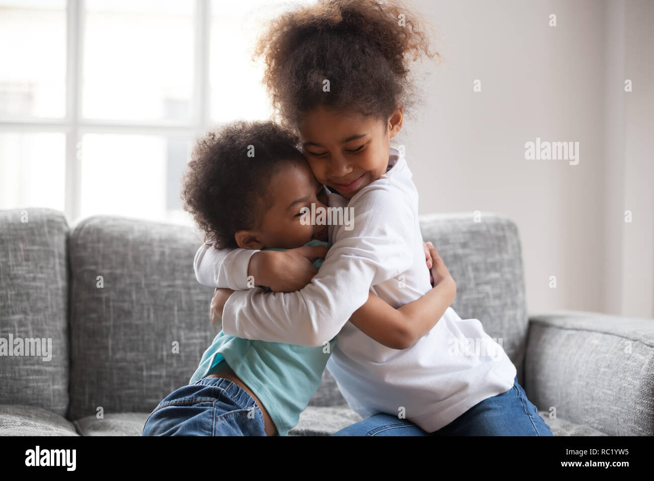 Cute happy african american siblings hugging cuddling feeling lo Stock ...