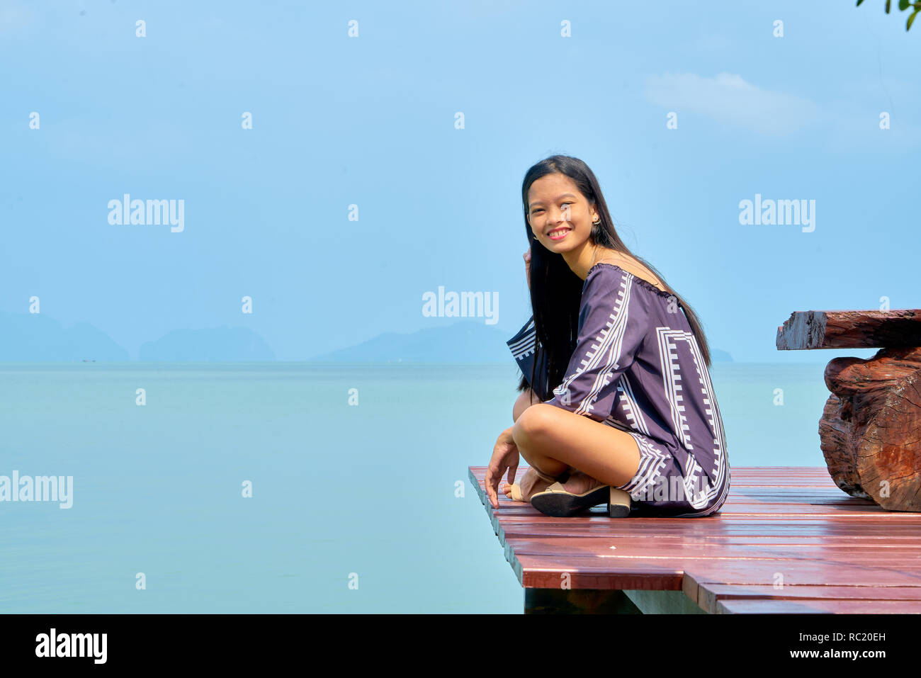 Beautiful woman posing - sitting side view, happy and enjoying Stock ...