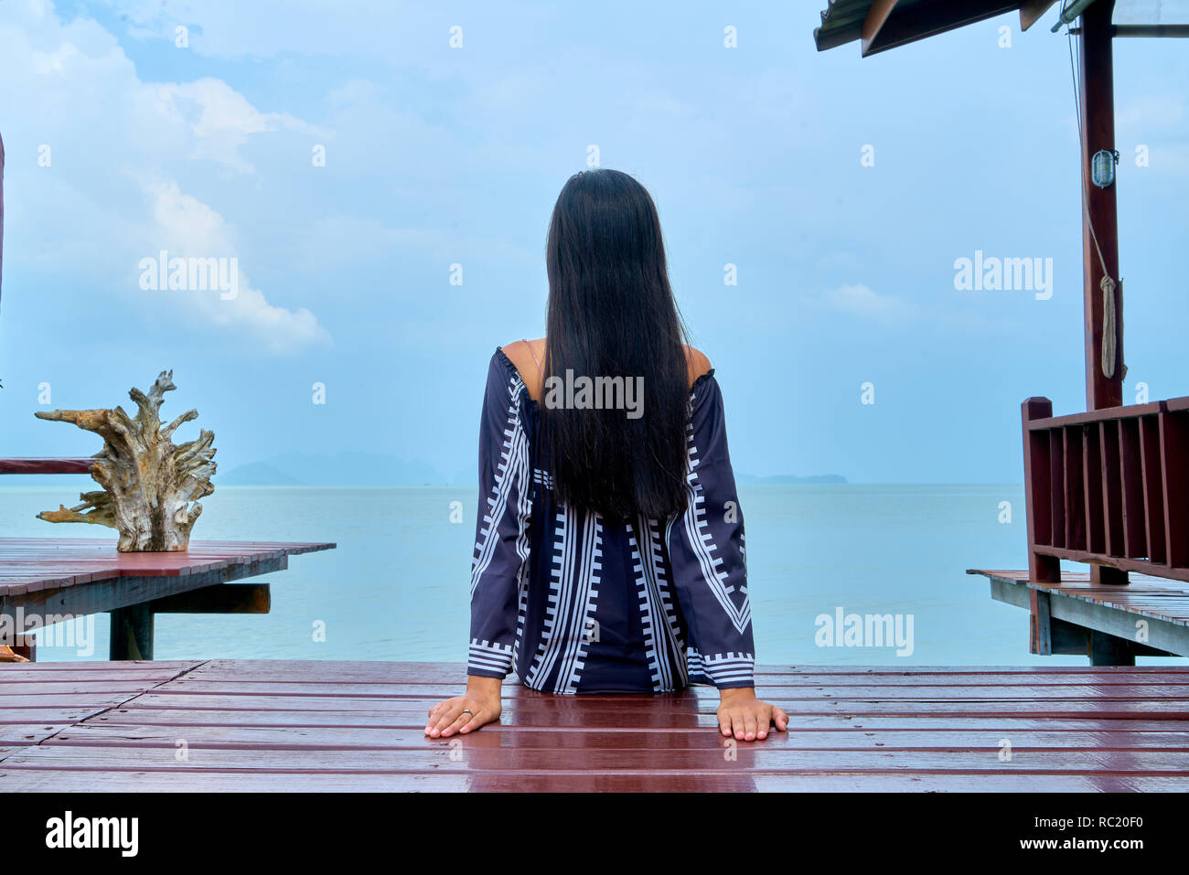Beautiful woman posing - sitting back view and relaxing Stock Photo - Alamy