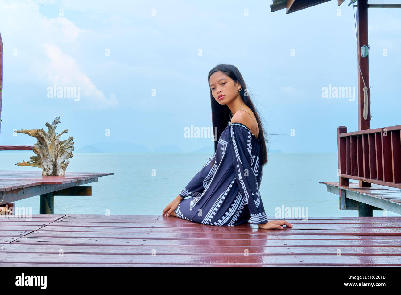 Beautiful woman posing - sitting back view, looking at camera and ...