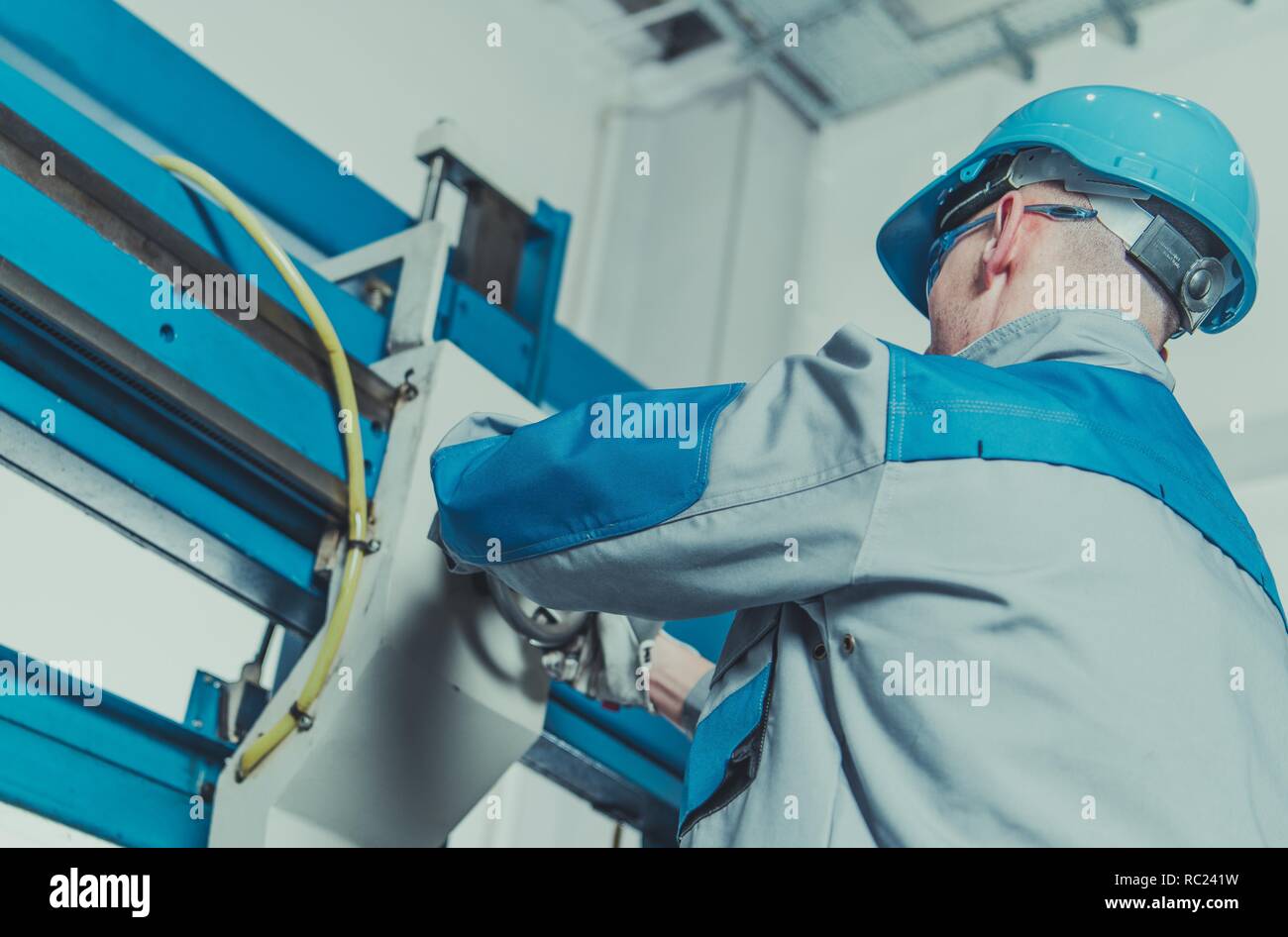 Heavy Duty Metal Guillotine Operator. Caucasian Worker in Blue Hard Hat ...