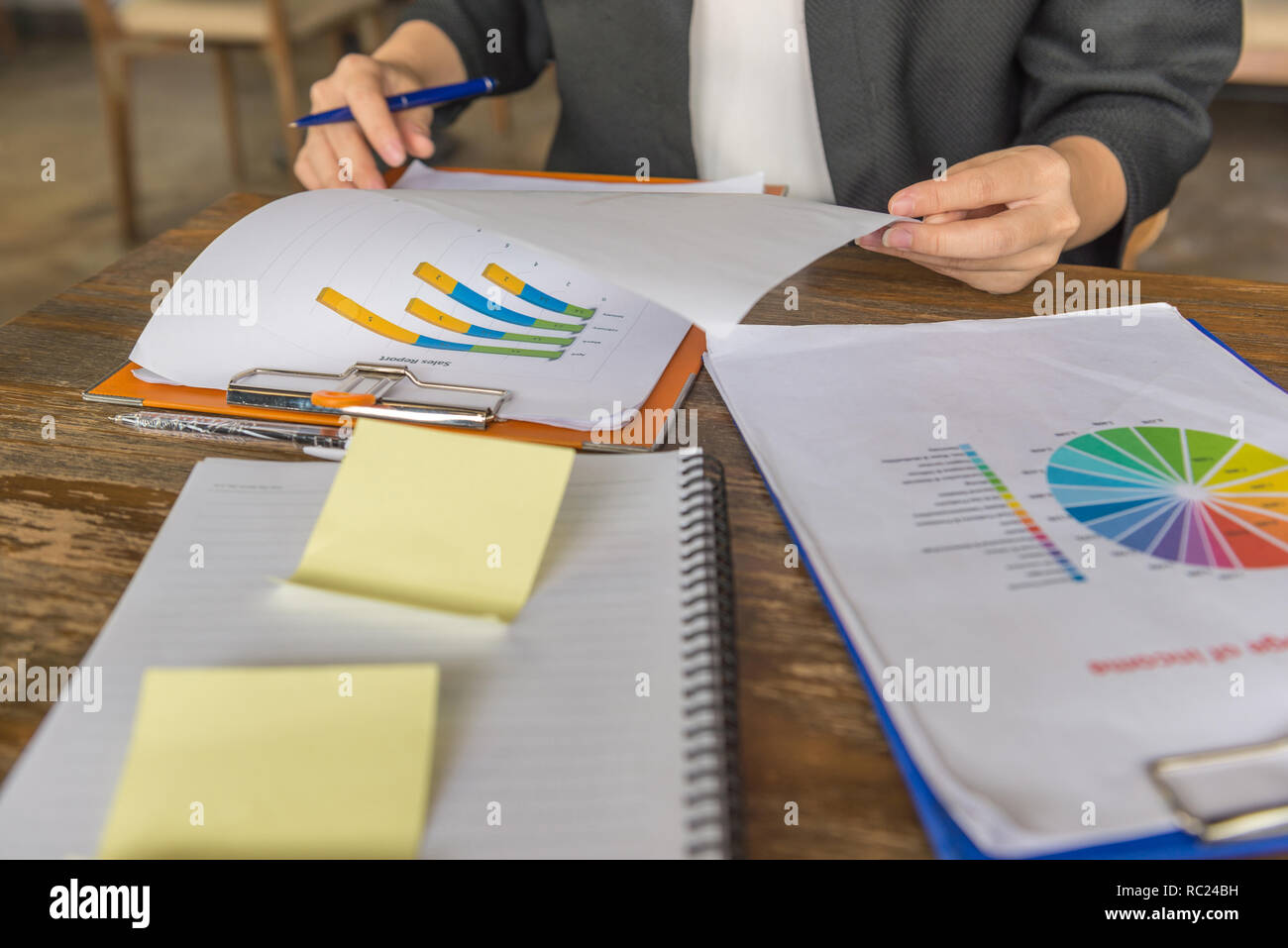Businesswoman reading report Stock Photo - Alamy