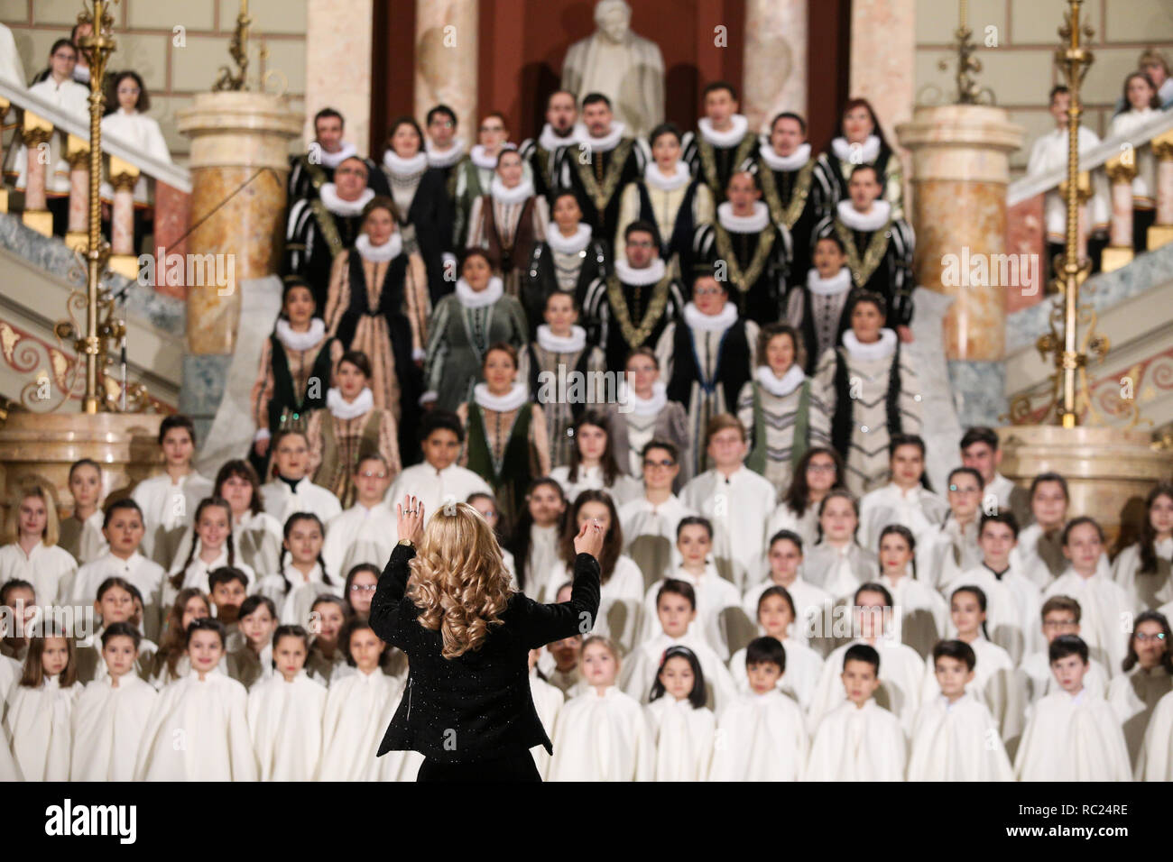 Back of a woman conducting a choir of children and adults Stock Photo ...