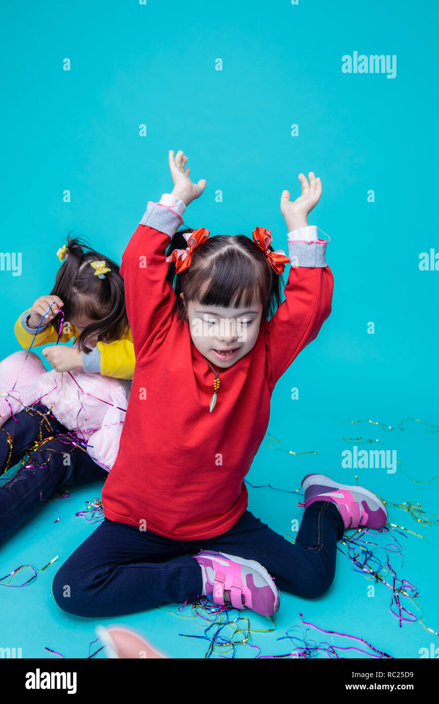 Happy little girls with genetic disorder playing with toys Stock Photo ...