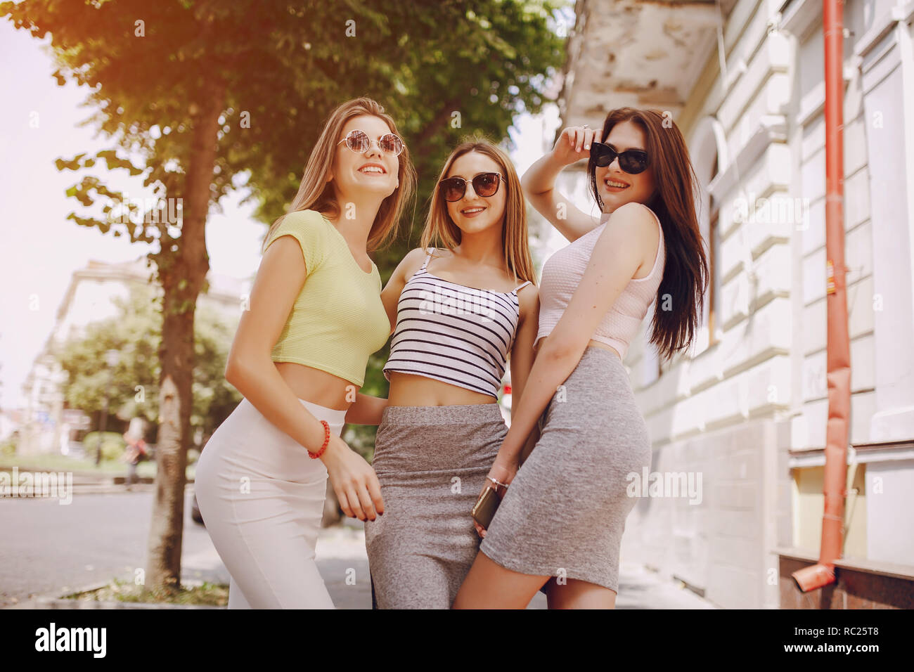 three beautiful girls walking around the city Stock Photo - Alamy