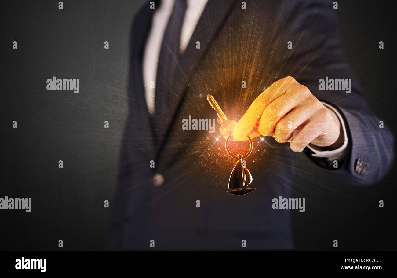 Formal man hand over shiny keys with dark background Stock Photo - Alamy
