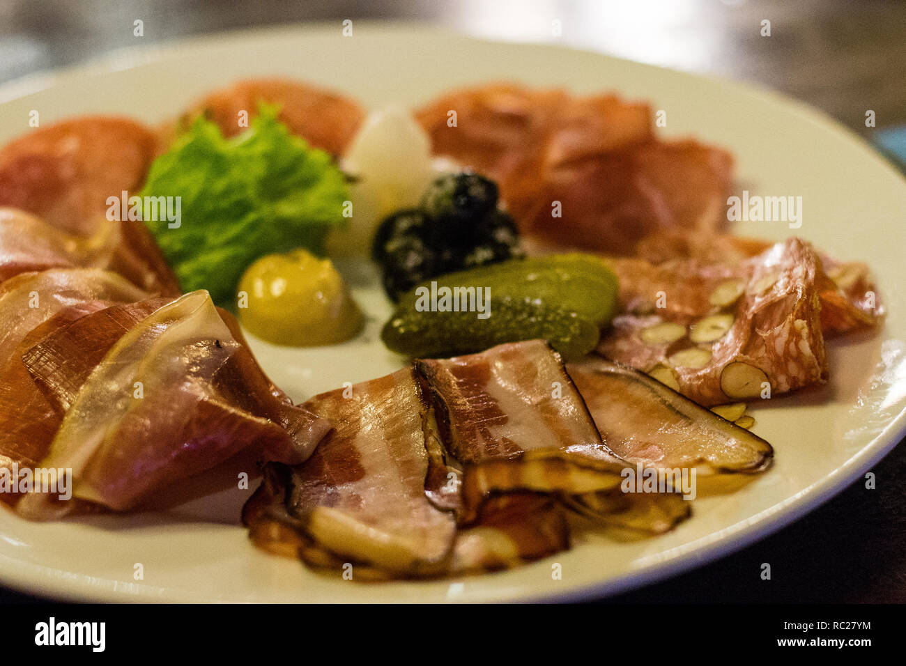cold cut meat platter with mustard, gherkins, pickles and pickled ...