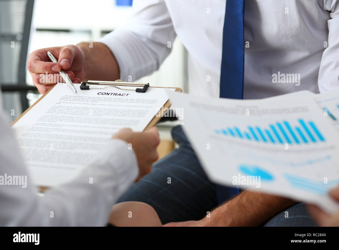 Male arm offer contract form on clipboard pad Stock Photo - Alamy