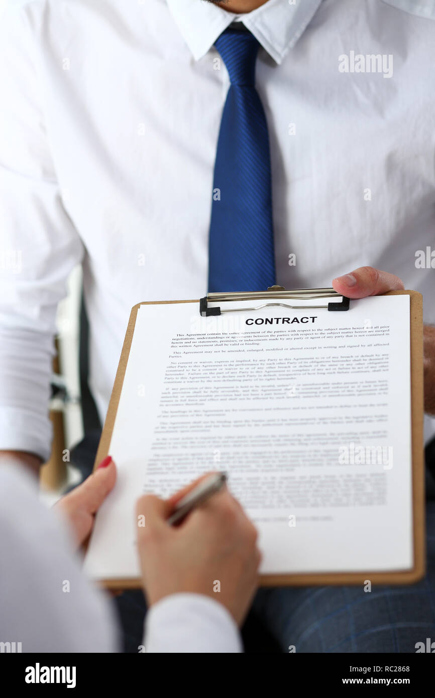 Male arm offer contract form on clipboard pad Stock Photo - Alamy