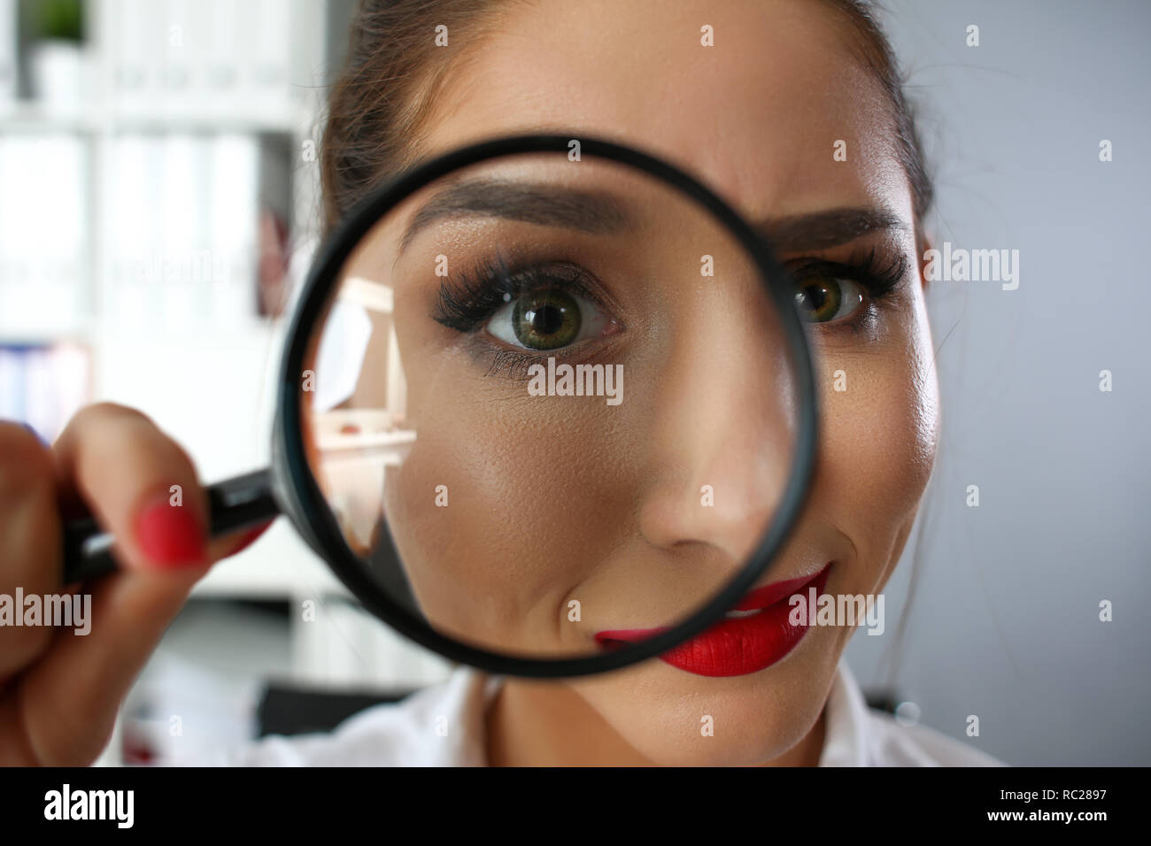 Funny smiling businesswoman hold in arm magnifier Stock Photo - Alamy