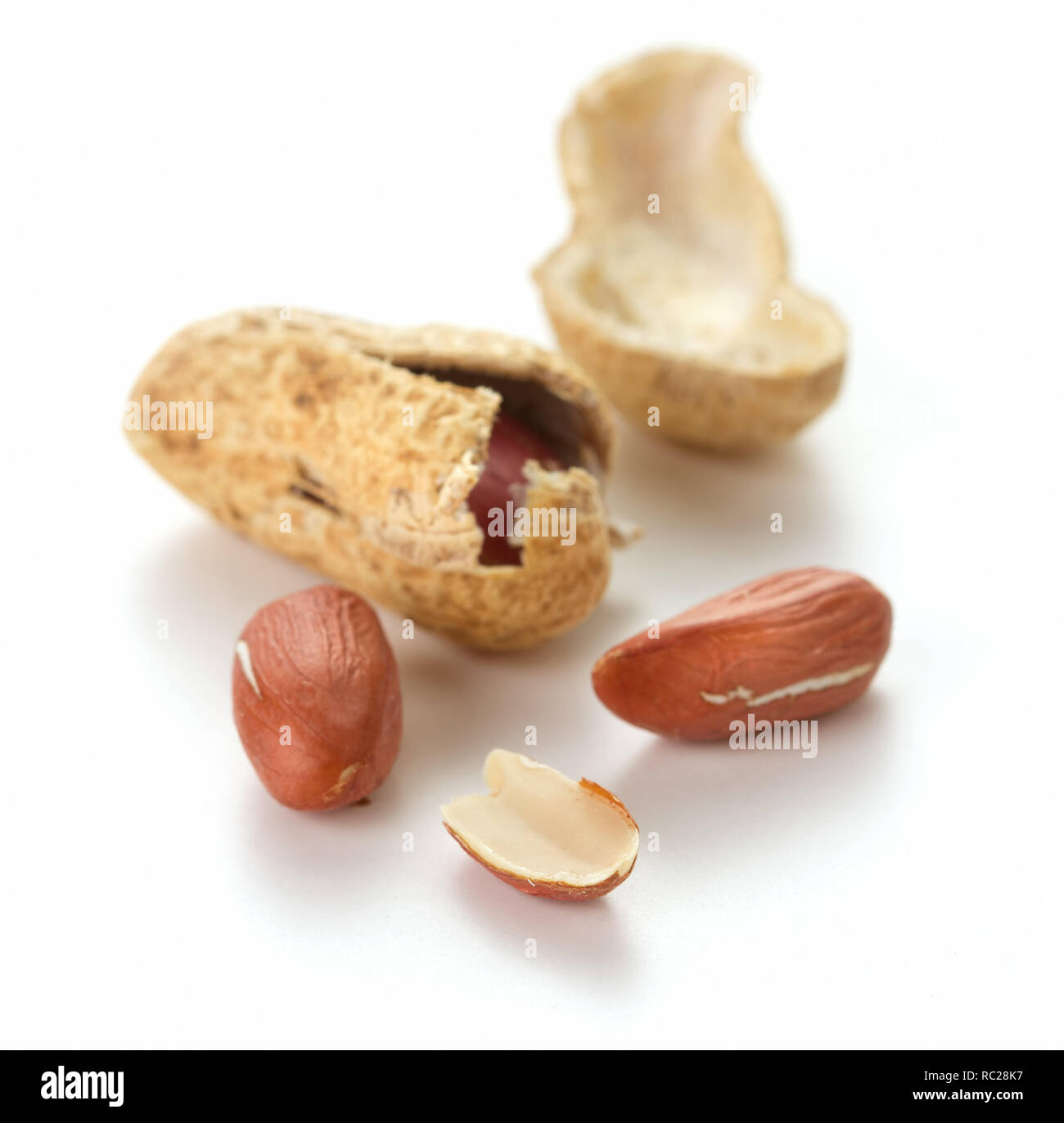 heap of cracked peanuts with on white background Stock Photo - Alamy