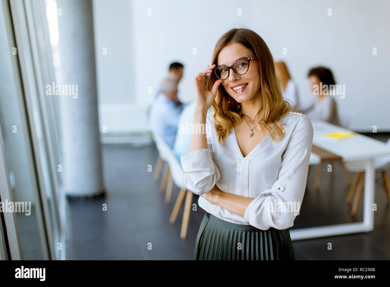 Young pretty attractive female manager standing in modern office Stock ...