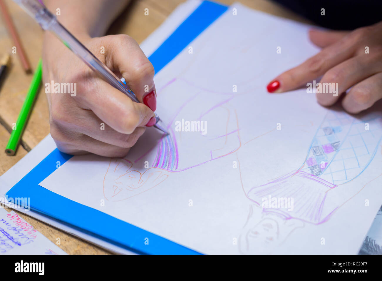 Close up shot - hands of professional tailor, designer drawing fashion ...