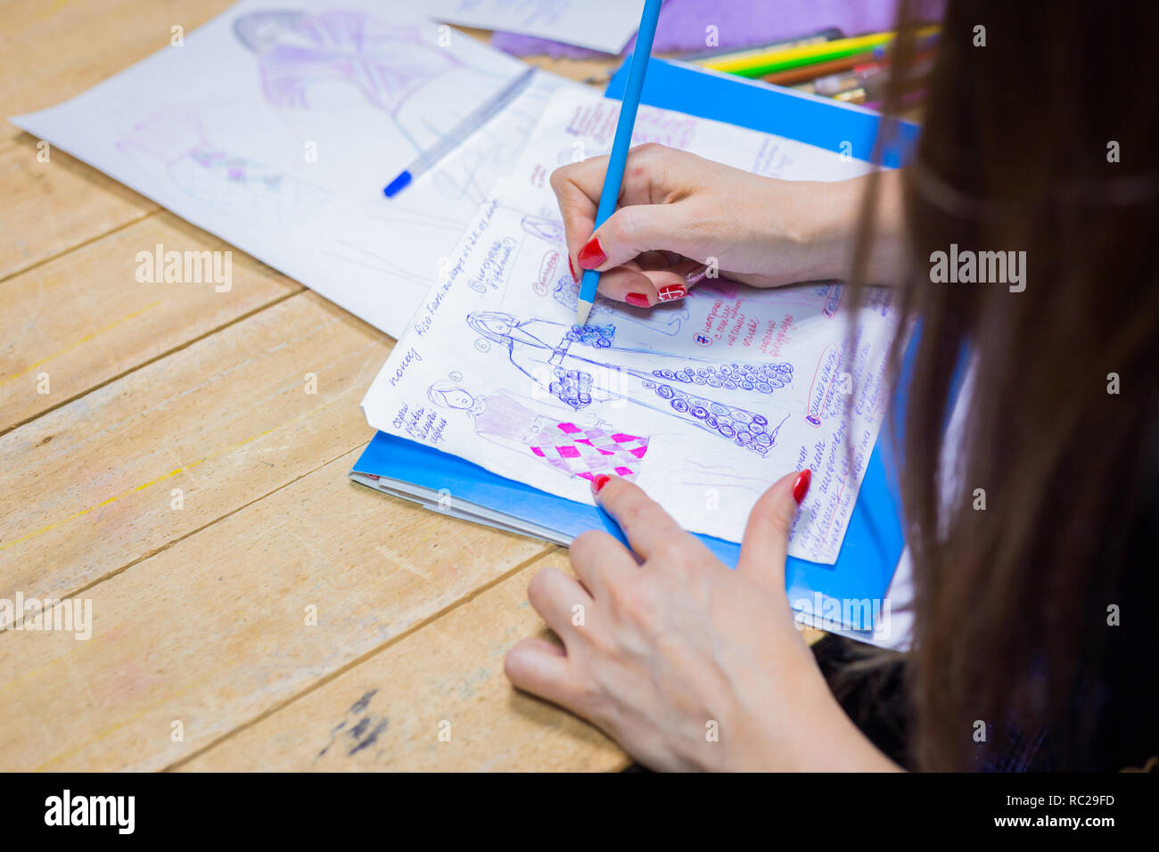 Close up shot - hands of professional tailor, designer drawing fashion ...